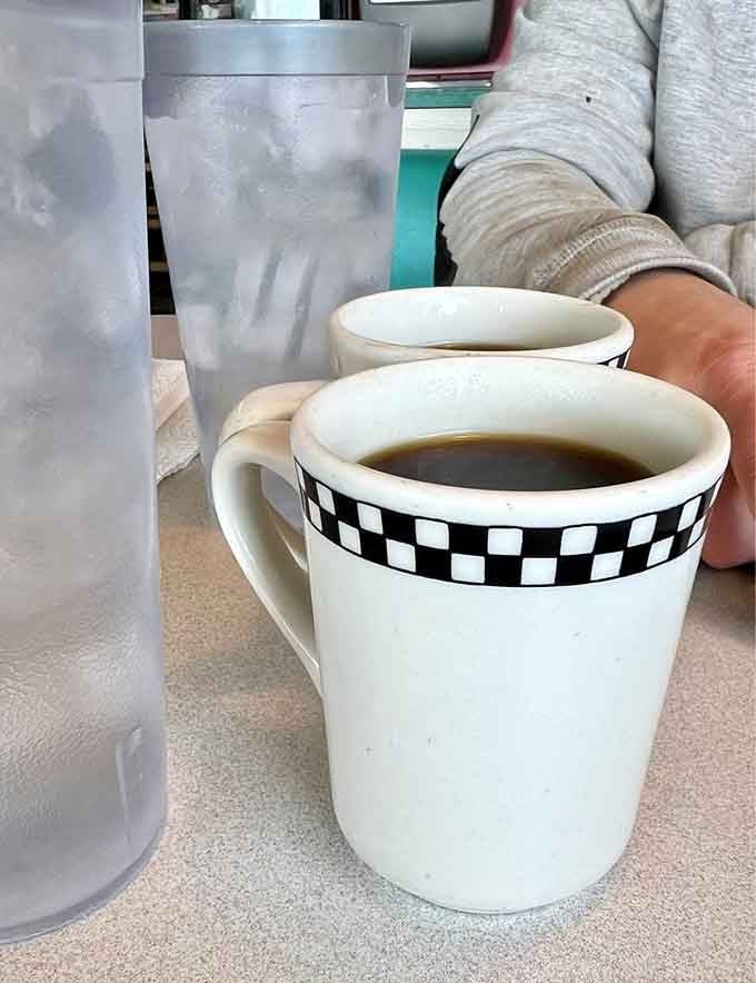 Even the coffee cups sport that classic checkered pattern, because consistency matters when you're creating an authentic experience.