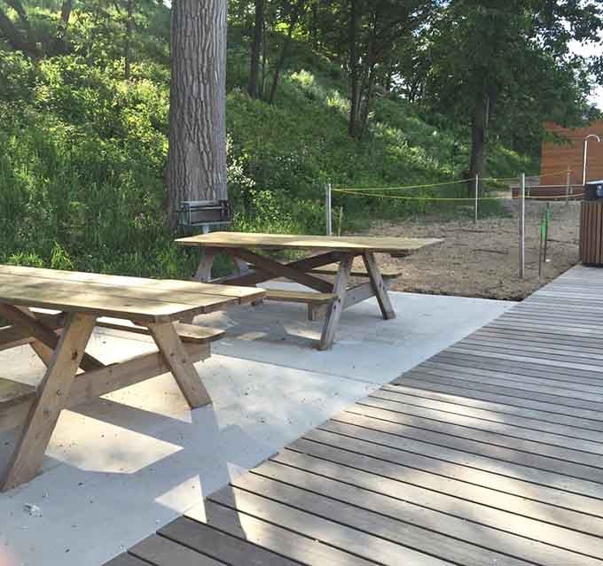 Picnic tables positioned perfectly for lunch with a view, turning your packed sandwiches into a lakefront dining experience.