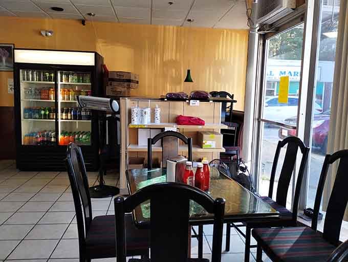 A cozy dining area with glass-topped tables where you can sit and contemplate your excellent donut choices.