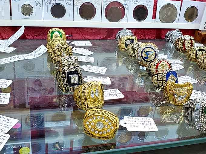 Championship rings gleam under glass, each one representing someone's moment of athletic glory and triumph.