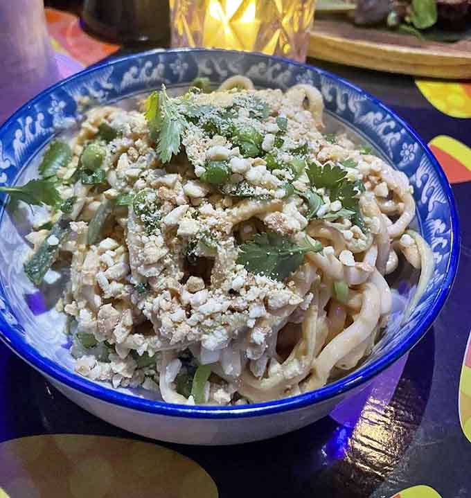 Noodles tangled with flavor, proving comfort food works just as well in paradise as it does anywhere.