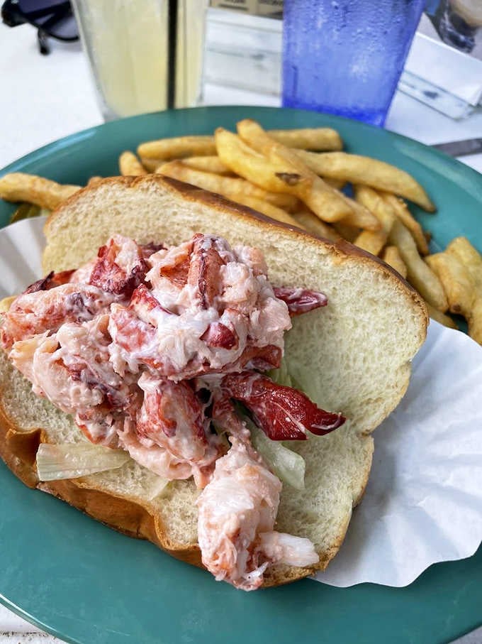 That lobster roll is packed so full of meat it's practically staging a rebellion against the bread holding it.