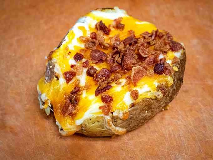 A loaded baked potato topped with cheese, sour cream, and bacon bits is basically comfort food's greatest hits album.