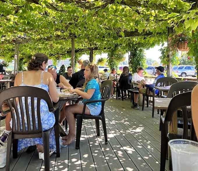 The outdoor patio where grapevines provide shade and every meal feels like a Mediterranean vacation without the jet lag hassle.