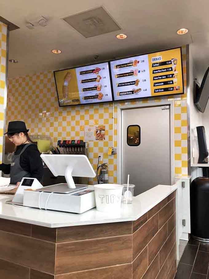The ordering counter where dreams of crispy corn dogs become reality, complete with those signature yellow tiles brightening your day.
