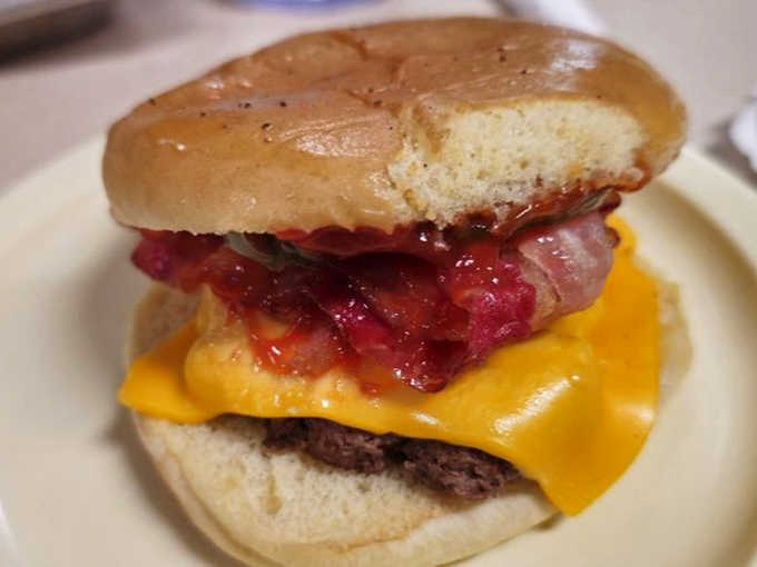 Bacon, beef, and cheese stacked high enough to require architectural planning and possibly a structural engineer's approval.