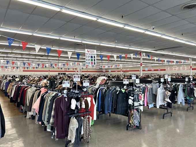 The interior stretches endlessly like a retail wonderland, decorated with patriotic bunting that screams Texas pride and bargain hunting glory.