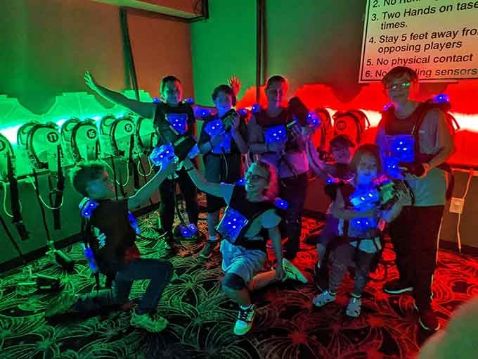 Laser tag warriors pose with their glowing vests, ready to battle like tiny sci-fi soldiers on leave.