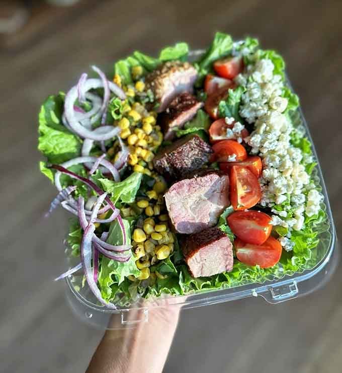 Fresh greens, perfectly grilled meat, and colorful toppings create a salad that actually looks worth eating enthusiastically.