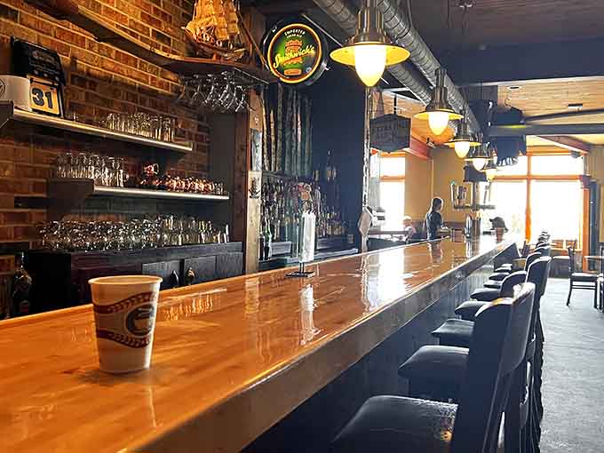 That polished bar stretches out like an invitation, promising cold drinks and warm conversations in equal measure throughout the evening.