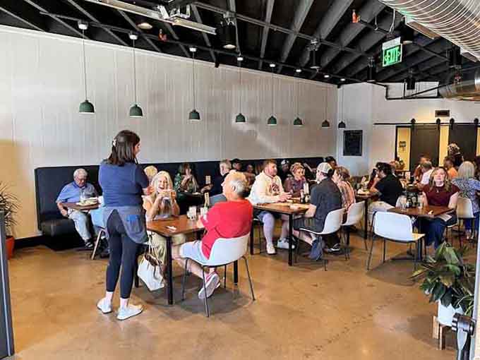 A full dining room of happy faces sharing meals and conversation, the way restaurants were meant to bring communities together.