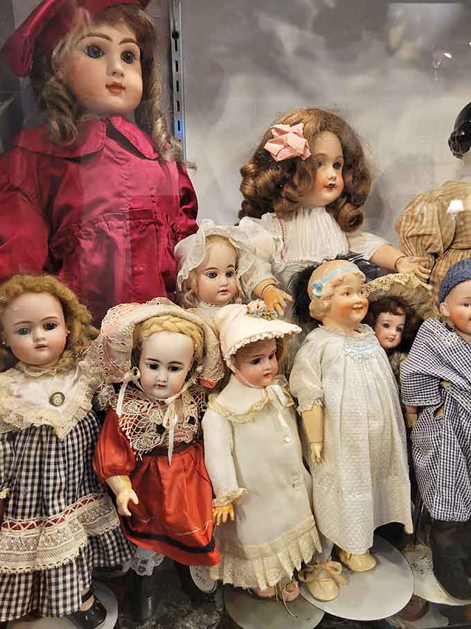 Antique dolls stare with those knowing eyes that have witnessed generations of playtime and family gatherings pass by.
