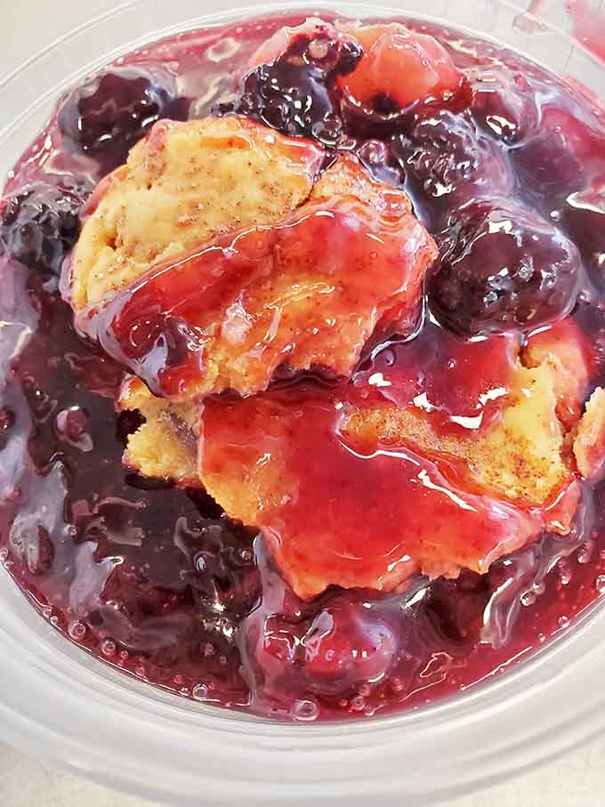 Cobbler swimming in berry goodness, the kind of dessert that makes you forget you just ate your weight in meat.