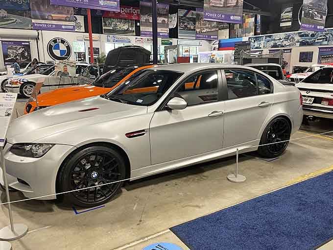 Sleek silver bodywork catches the light like polished jewelry in a showroom of automotive gems.