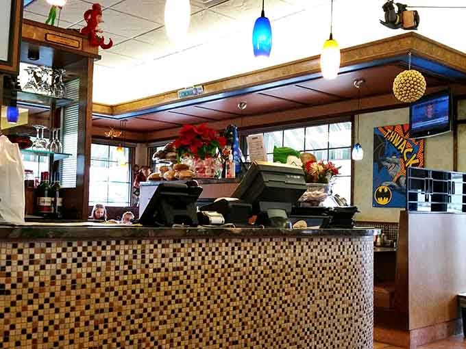 The order counter showcases even more collectibles, turning a simple pickup spot into a mini superhero museum display.