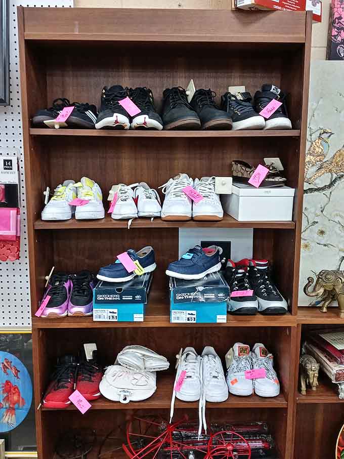 Footwear organized by shelf, because even secondhand shoes deserve their moment to shine in proper retail fashion display glory.