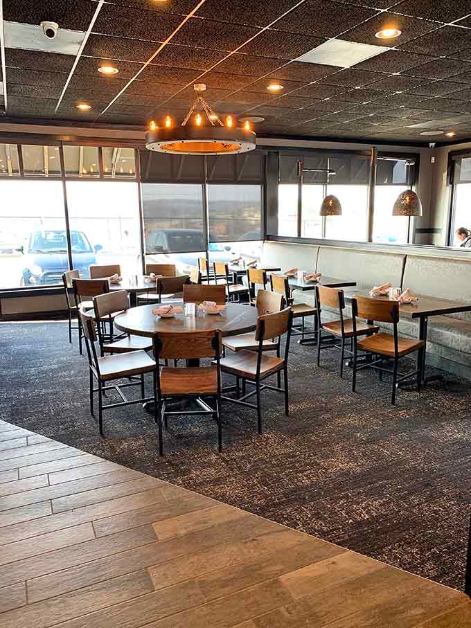 Round tables and pendant lighting create an inviting atmosphere where good food meets good company every single time.
