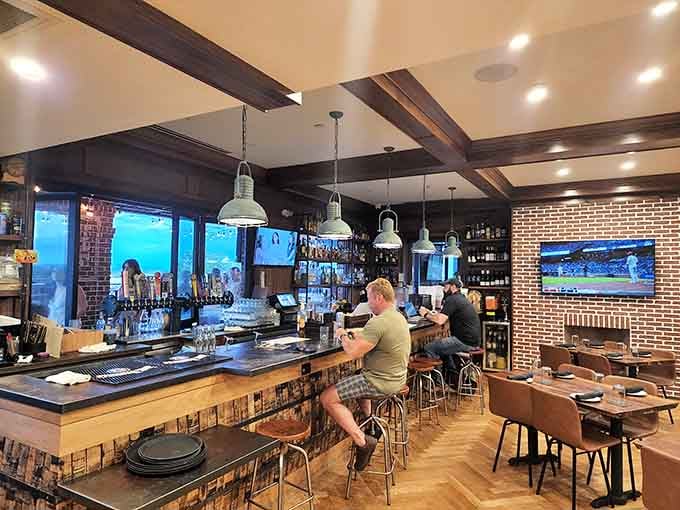 The bar area invites you to settle in, with exposed brick and enough bottles to keep things interesting.