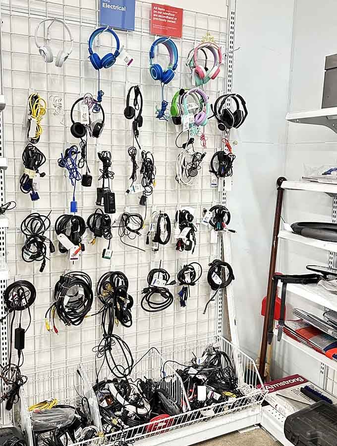 Headphones and cables hang like technological vines, connecting you to entertainment from every era imaginable.