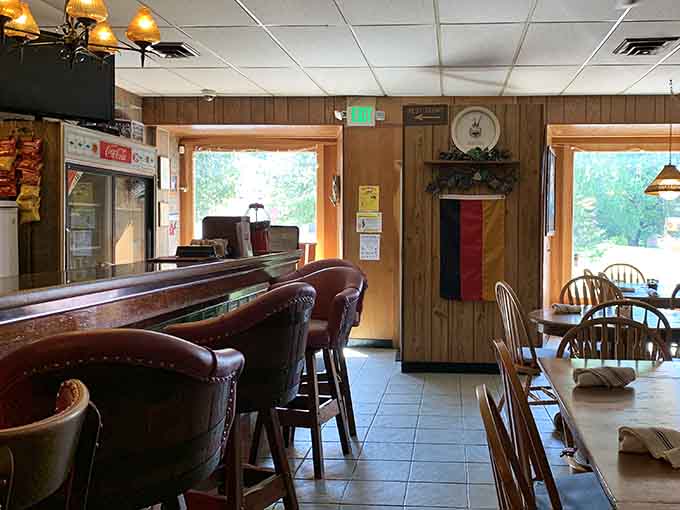 The bar area beckons with its rich wood tones and European flair, perfect for a pre-dinner drink or post-chicken celebration.