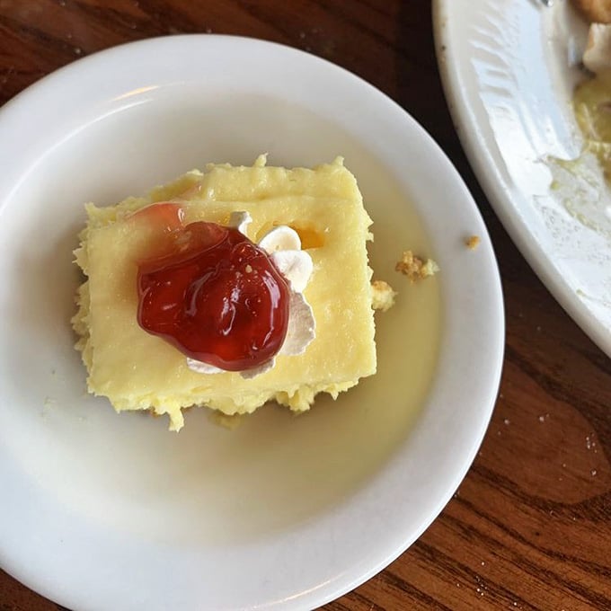 Homemade cheesecake swimming in butter sauce provides the sweet finale that transforms a great meal into an unforgettable dining experience.