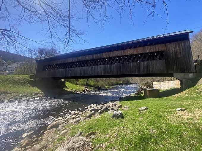 Spring brings fresh grass and flowing water, framing the bridge like nature's own picture mat around historic craftsmanship.