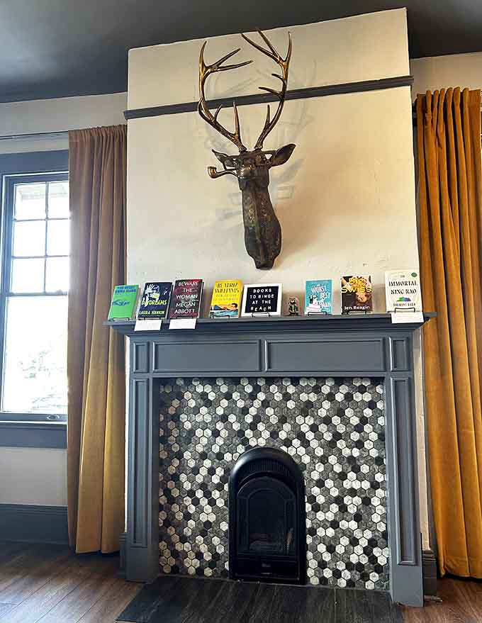 A decorative deer presides over the fireplace mantel, silently judging your book choices with woodland wisdom.