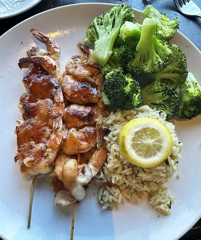 Bacon-wrapped shrimp with rice and broccoli, proving that everything really is better with bacon, even in the Ozarks.