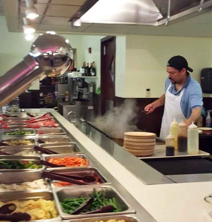 The Mongolian barbecue station where skilled chefs transform your random ingredient selections into something that actually tastes intentional.