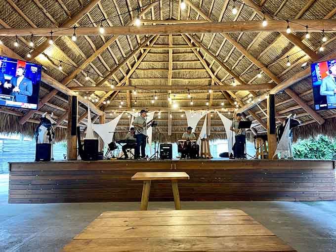 Live music under a thatched roof pavilion, because shopping is better with a soundtrack and atmosphere.