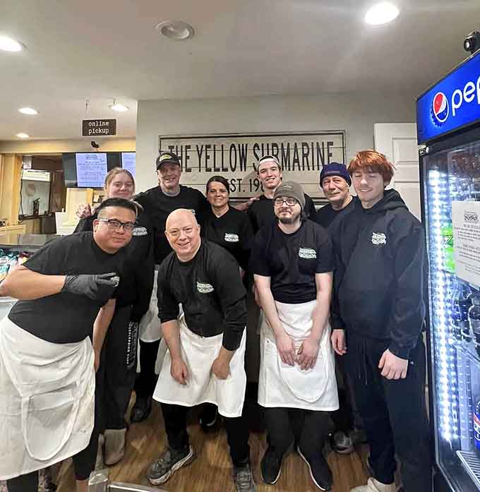 A team that clearly takes pride in their work, smiling because they know what's leaving that kitchen is legit.