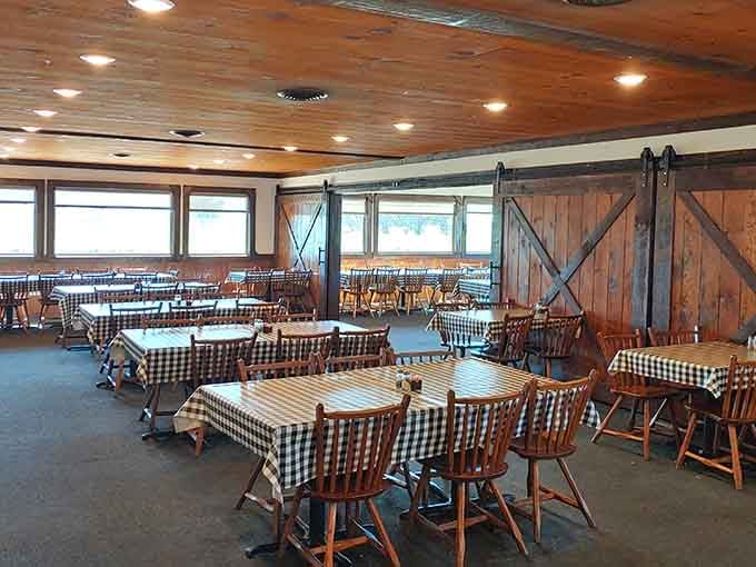 Spacious dining room with barn doors and rustic charm. Simple elegance that lets the food steal the spotlight.