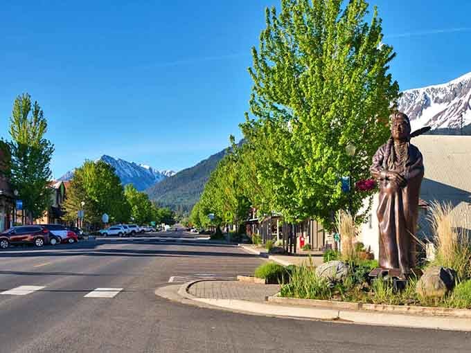 Mountains frame the main street while a bronze statue stands watch, honoring heritage with quiet dignity and pride.
