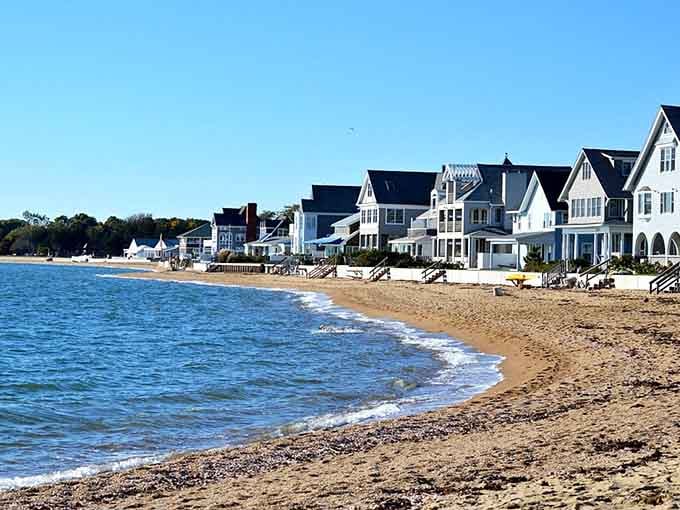 Elegant beach houses line the shore creating a scene straight from a coastal living magazine.