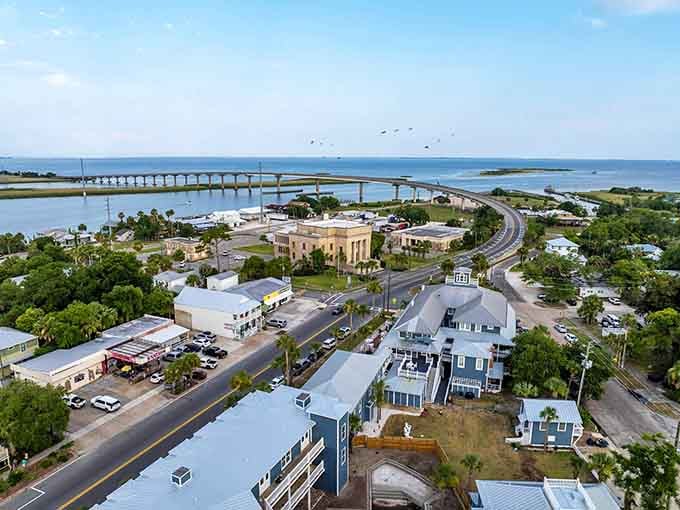 From this bird's-eye view, the bridge arcs toward the Gulf while the town nestles peacefully between water and sky.