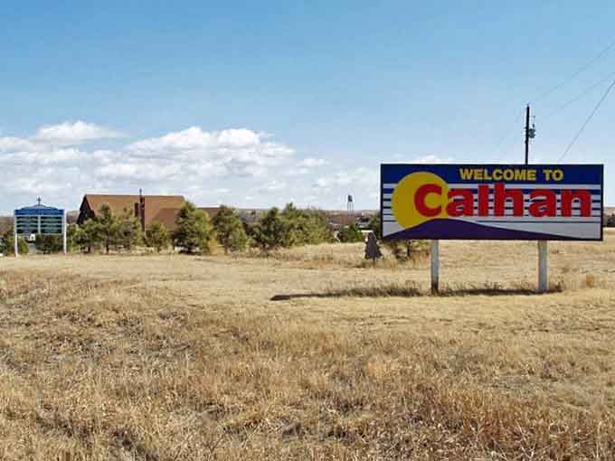 Golden prairie grass frames a welcome sign for a town where wide horizons meet down-to-earth hospitality every single day.