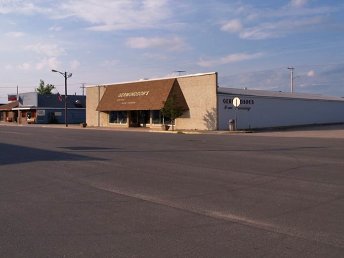 Wide-open streets and modest storefronts define prairie-town simplicity, where handshakes still seal deals and word remains bond.