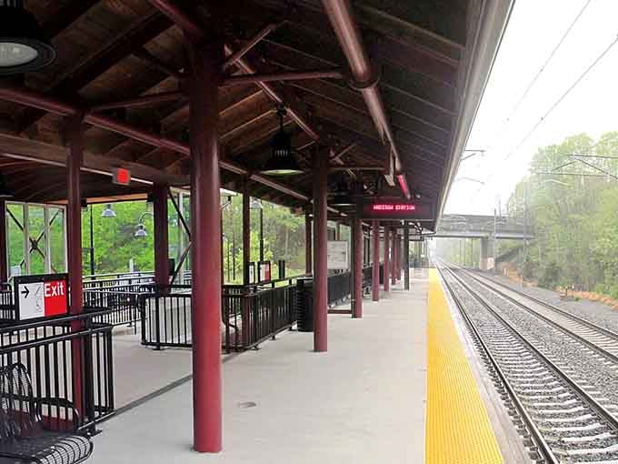 The vintage train platform with its burgundy columns waits patiently for the next journey to begin.