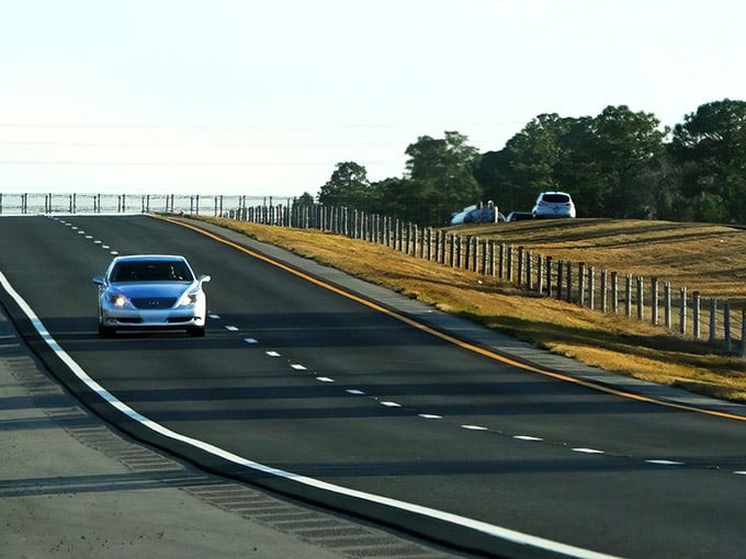 Morning light catches the smooth curves of this modern highway as it rolls through surprisingly hilly terrain.