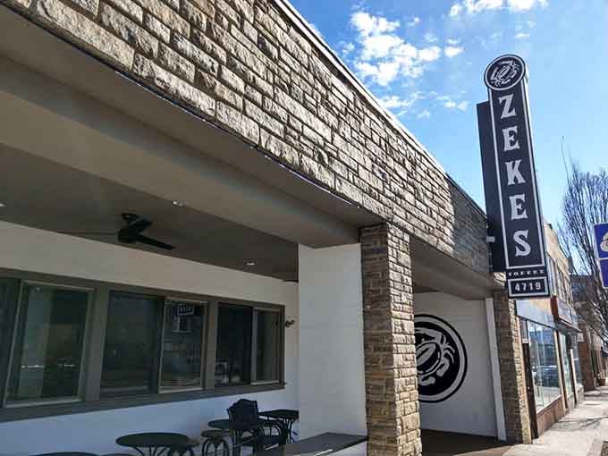Clean white exterior with modern stonework creates a sleek, contemporary vibe for serious coffee enthusiasts.