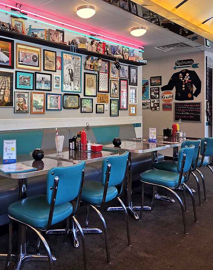 Pink neon lighting and vintage memorabilia covering every wall make this dining room feel like a museum you can actually eat in.