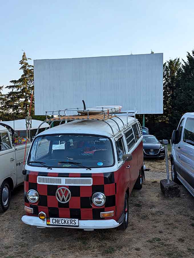 A checkered VW van at a drive-in is either someone's retirement dream or their midlife crisis, possibly both, definitely awesome.