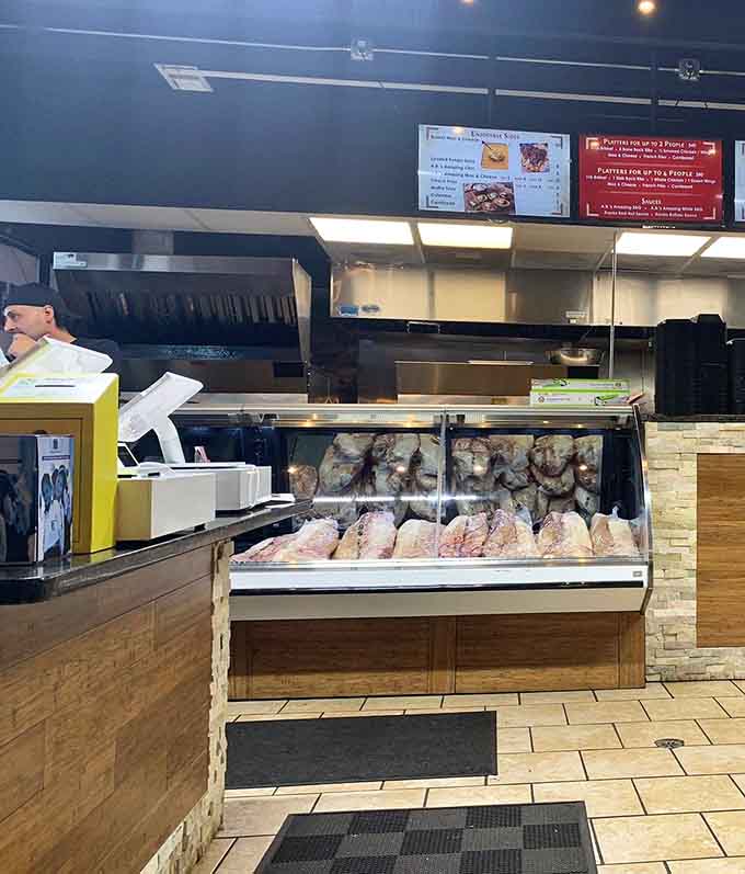 The order counter displays fresh cuts ready for smoking, offering transparency about what goes into your meal.