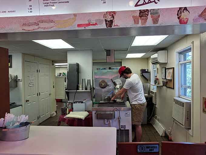 Behind the counter, skilled hands work the custard machines with the kind of practiced precision that turns simple ingredients into pure magic.