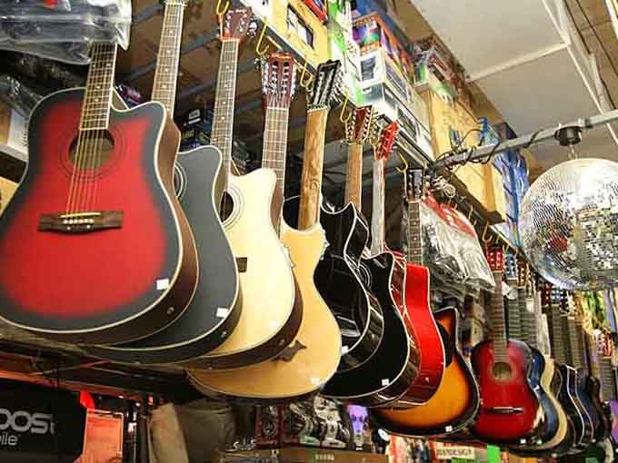 Guitars hanging overhead create a musical canopy, tempting everyone to finally learn that song they've been humming for years.