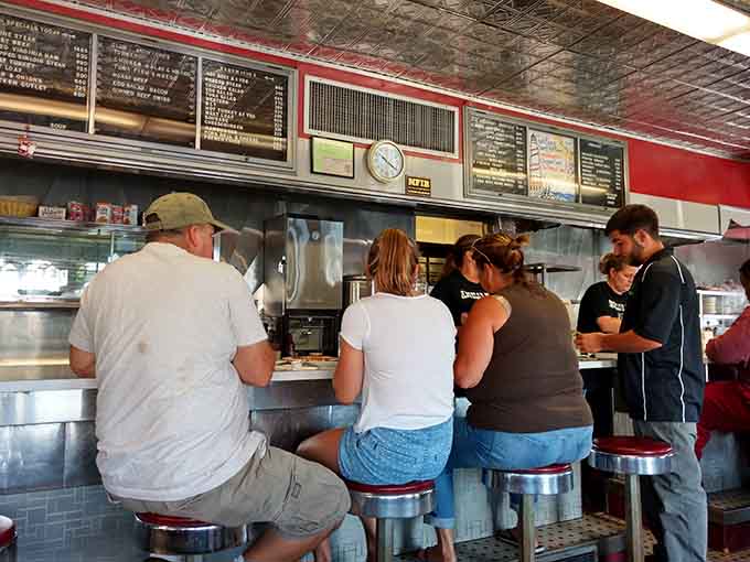 Counter seating where strangers become friends over eggs and the morning's first cup of joe.