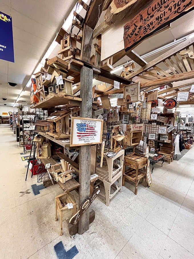Wooden birdhouses climb toward the ceiling on rustic posts, each one a tiny architectural marvel waiting patiently.