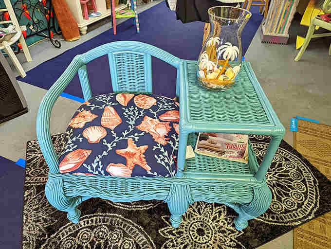 This turquoise conversation chair with seashell cushions screams "coastal living" louder than a Jimmy Buffett concert at sunset.