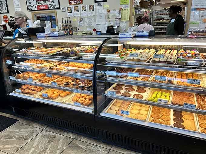 Two full display cases of temptation, organized like a sugary library where every book is delicious and edible.