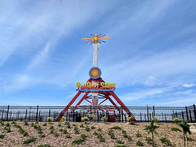 The Falling Star ride captures riders mid-swing against dramatic clouds, freezing a moment of pure adrenaline and questionable life choices.